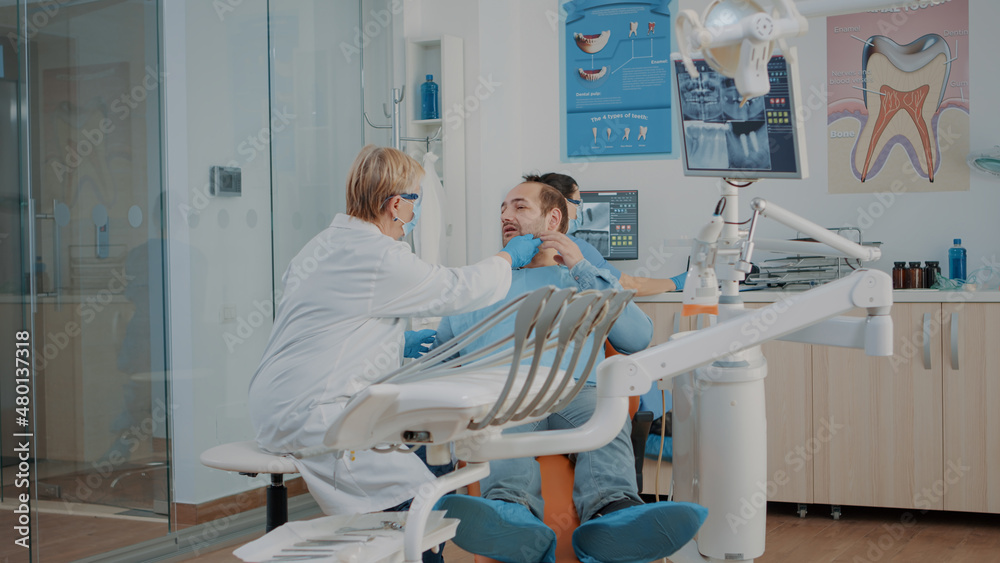 Dental expert doing examination to treat patient with caries in ...