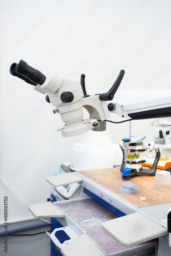 Microscope in a dental laboratory, a technician's workplace in a dental ...
