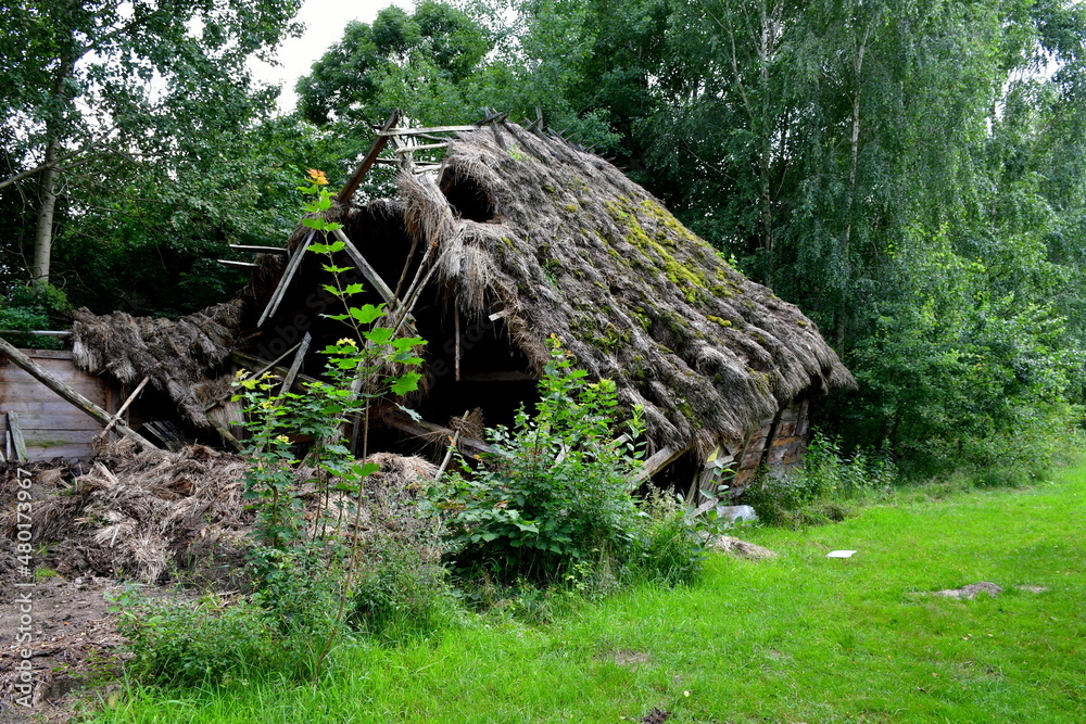 A close up on a damaged, destroyed, and dilapidated barn, house, or ...