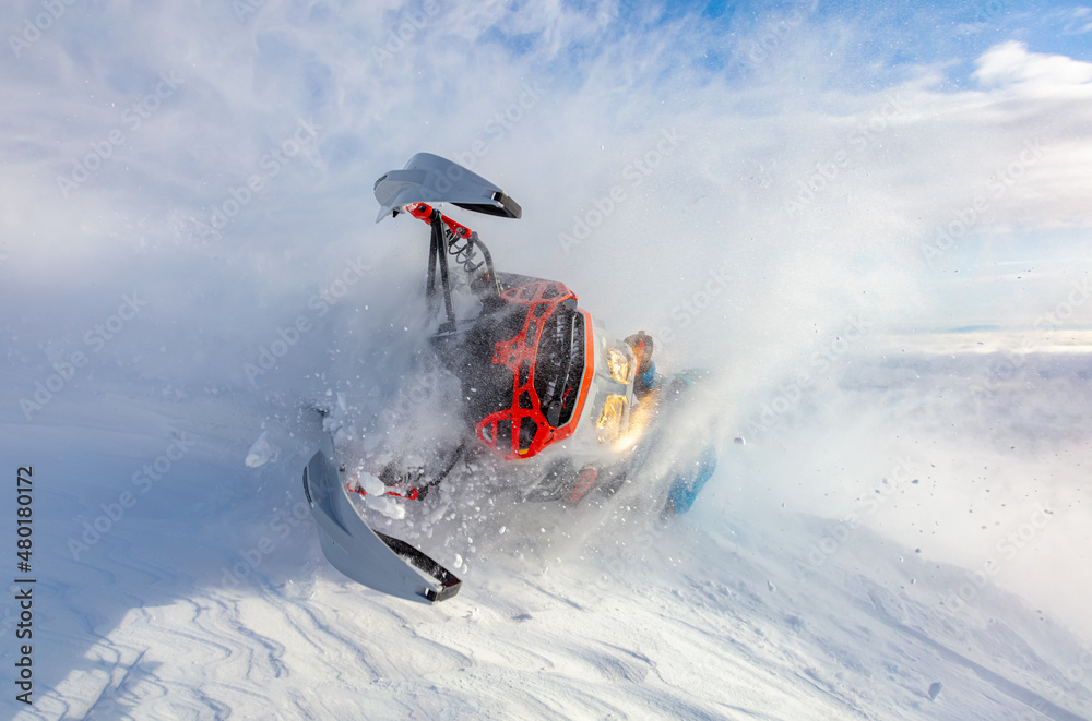 a beautiful and steep turn of a snowmobile in a close-up fall. a very ...