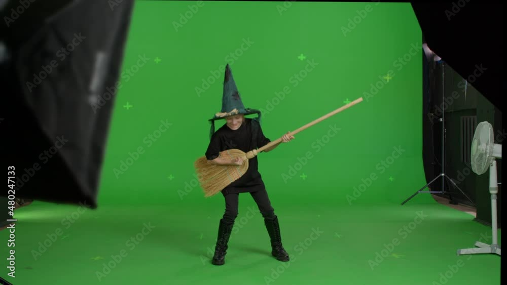 Happy smiling caucasian girl wearing witch hat for halloween parties ...