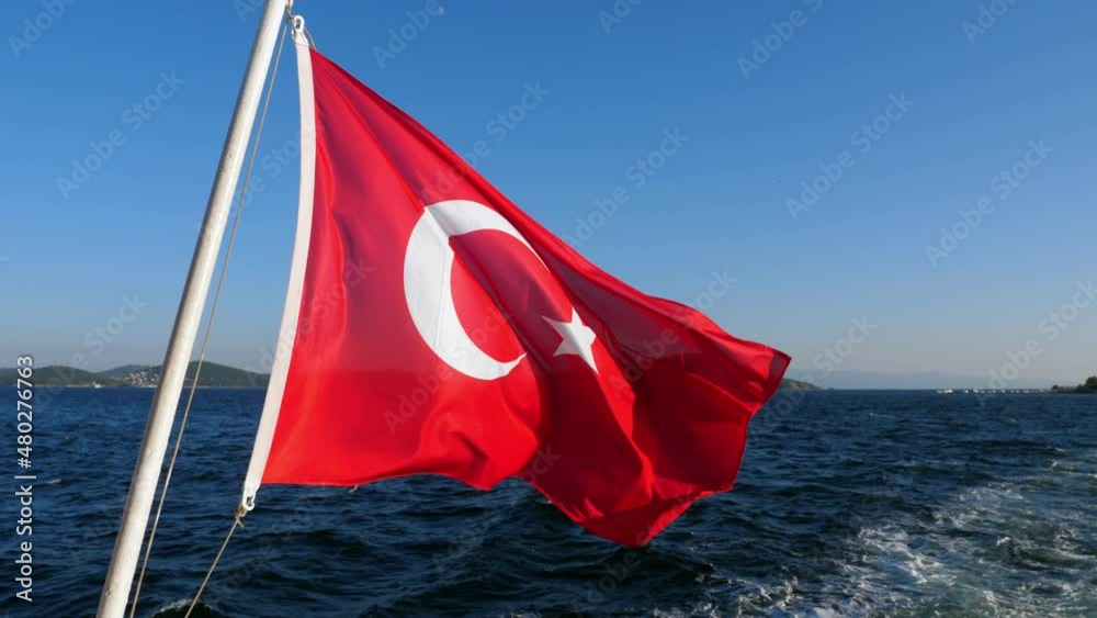 Turkish flag is flying in the wind against the background of Adalar and ...