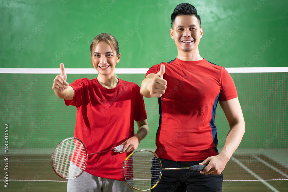 Two badminton players standing with thumbs up Stock Photo | Adobe Stock