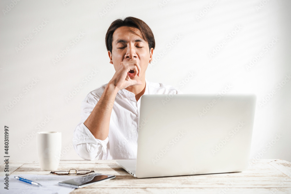 Male overwork. Tired Asian young man in white shirt alone in a white ...
