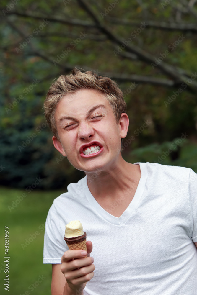 Teenage Boy With A Brain Freeze After Eating An Ice Cream Cone Stock
