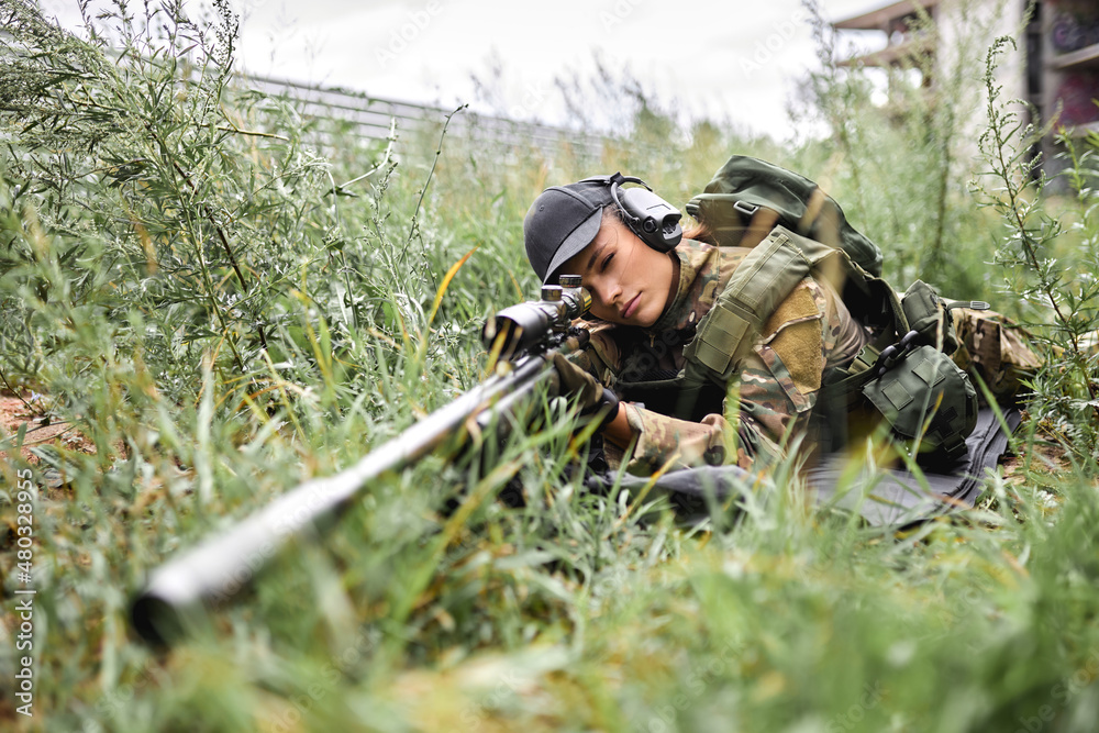 military woman in gear with rifle with an optical sight. Athlete ...
