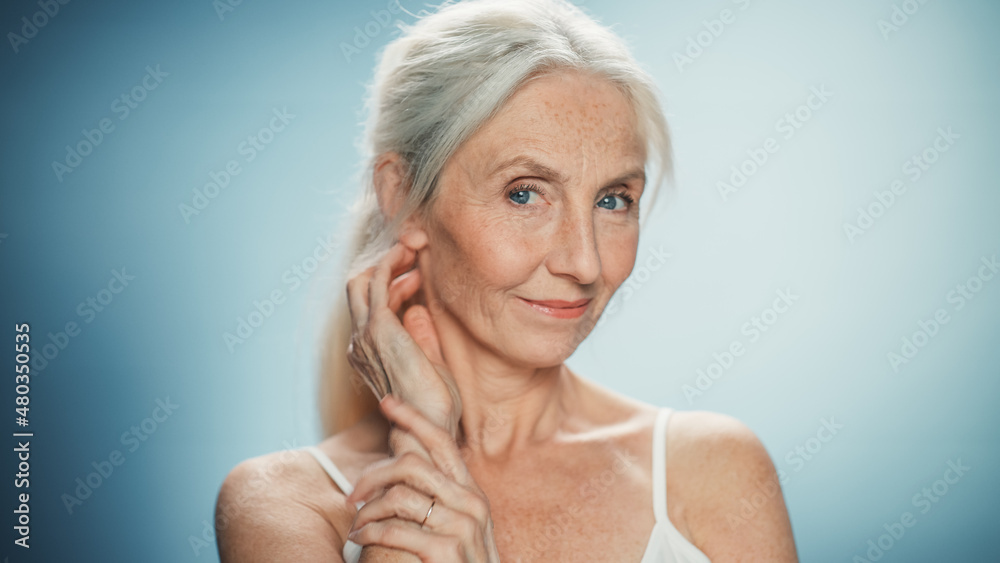 Close-up Portrait of Senior Woman Looking at Camera, Touching Hair ...