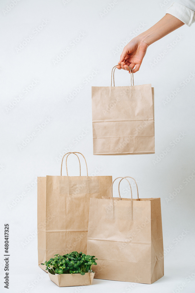 Hand bringing empty brown paper bag, placing next to the rest Stock ...