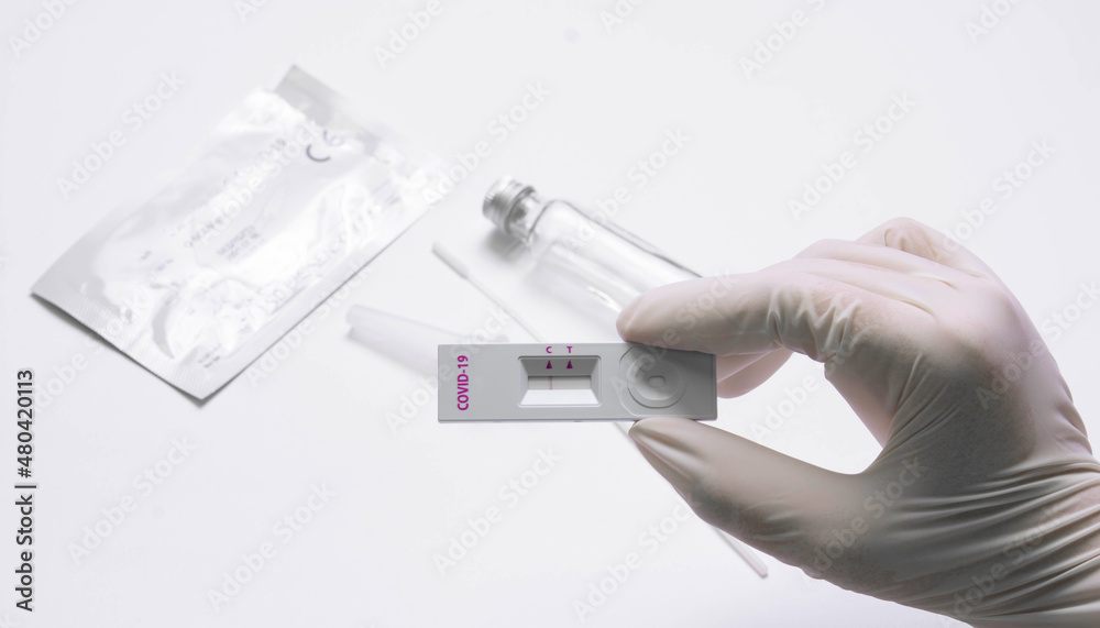 Doctor holding a COVID-19 test kit Test results are negative, not ...