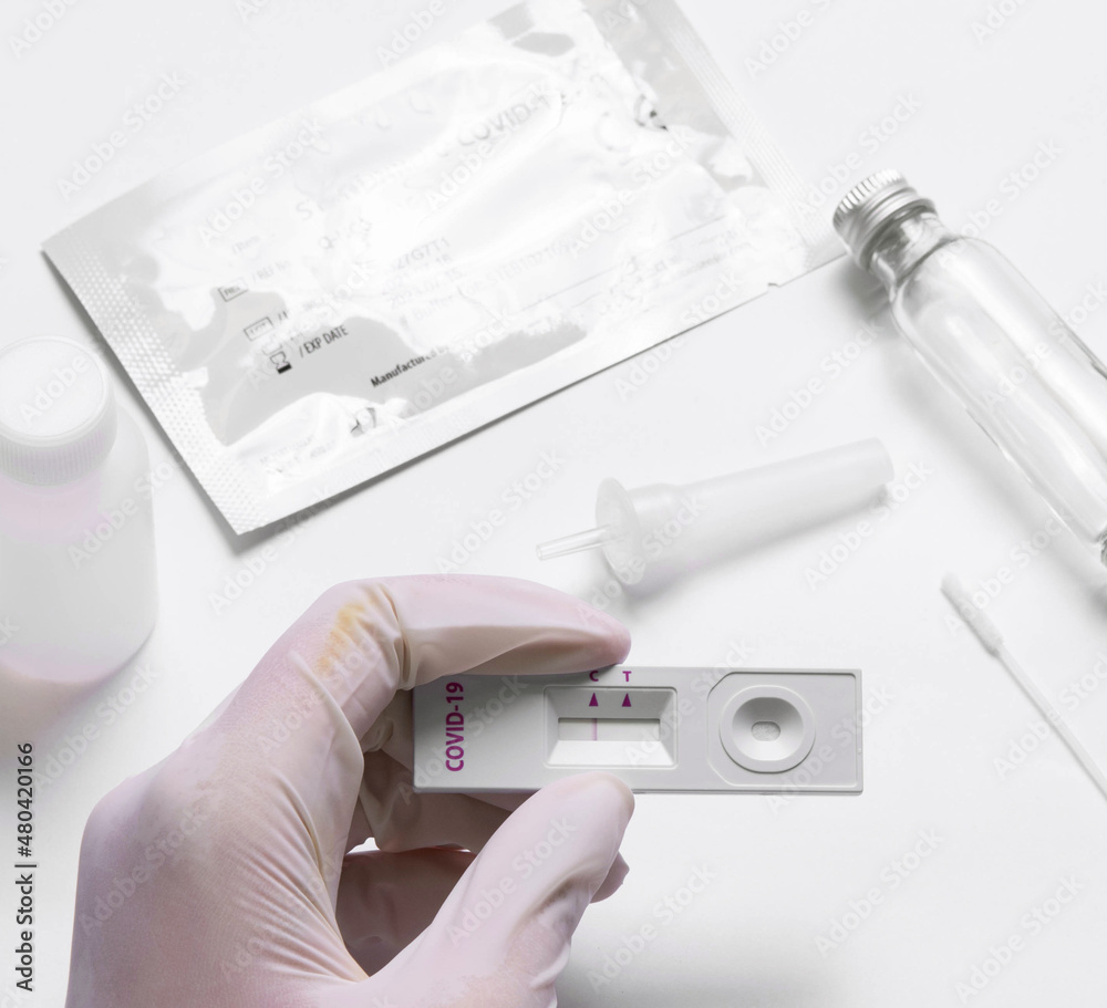 Doctor holding a COVID-19 test kit Test results are negative, not ...