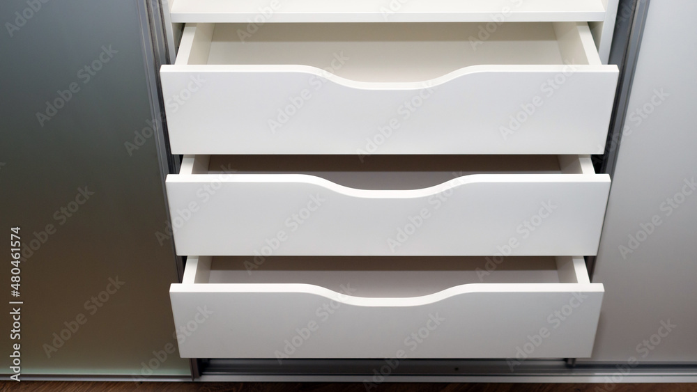 Open drawers for storage in a cabinet with mortise handles, a modern ...