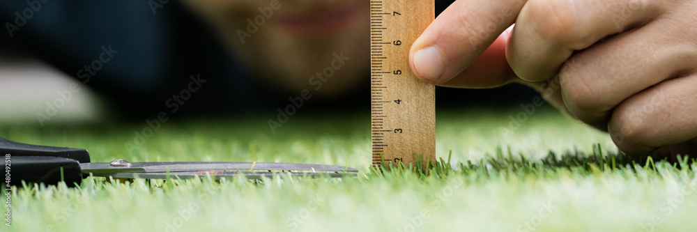 Photo & Art Print Man Using Measuring Scale While Cutting Grass, Andrey ...