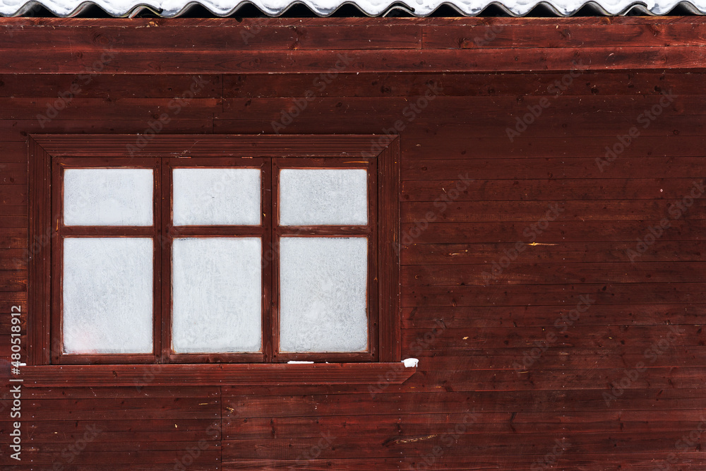 Brown wall of a wooden residential building. There is a three-section ...