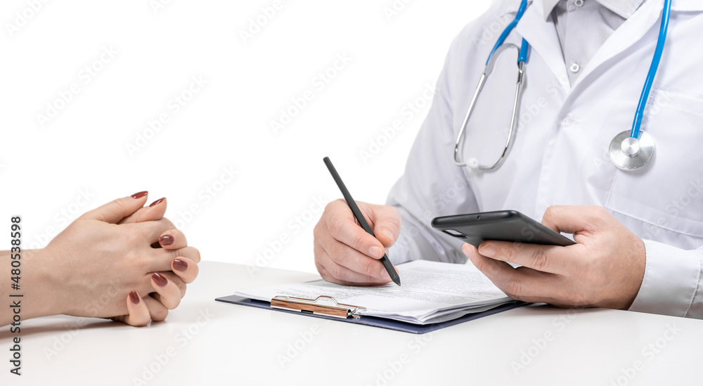 Patient and doctor taking notes. Doctor prescribing medication for ...