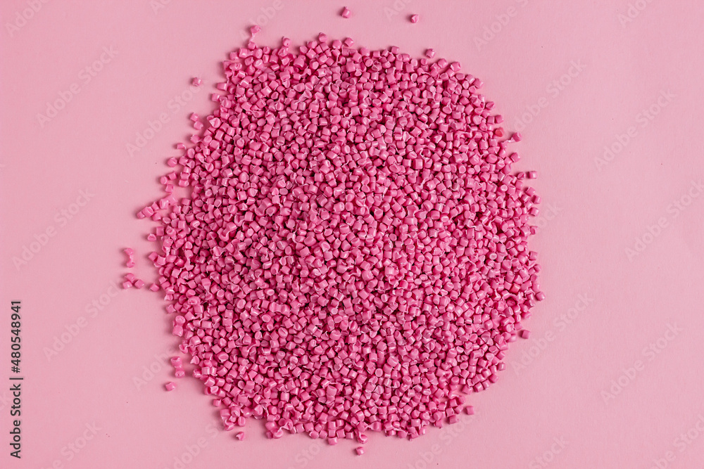 Pink granules of polypropylene or polyamide. background. Plastics and ...