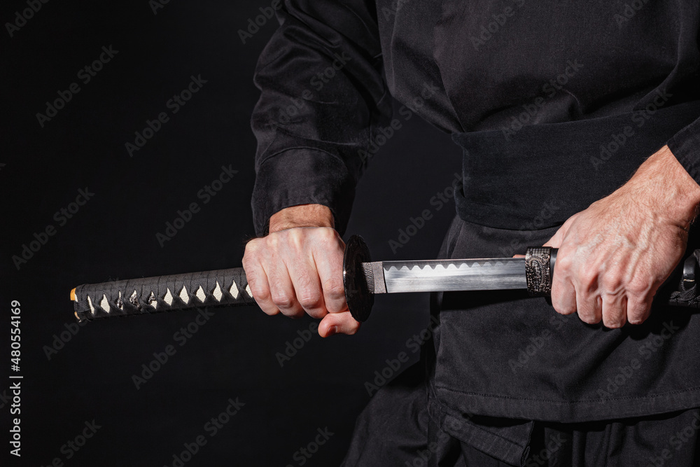 The samurai holding a Japanese katana sword. Photo of a warrior dressed ...