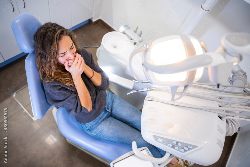 Young female patient frightened at the dental clinic Stock Photo ...