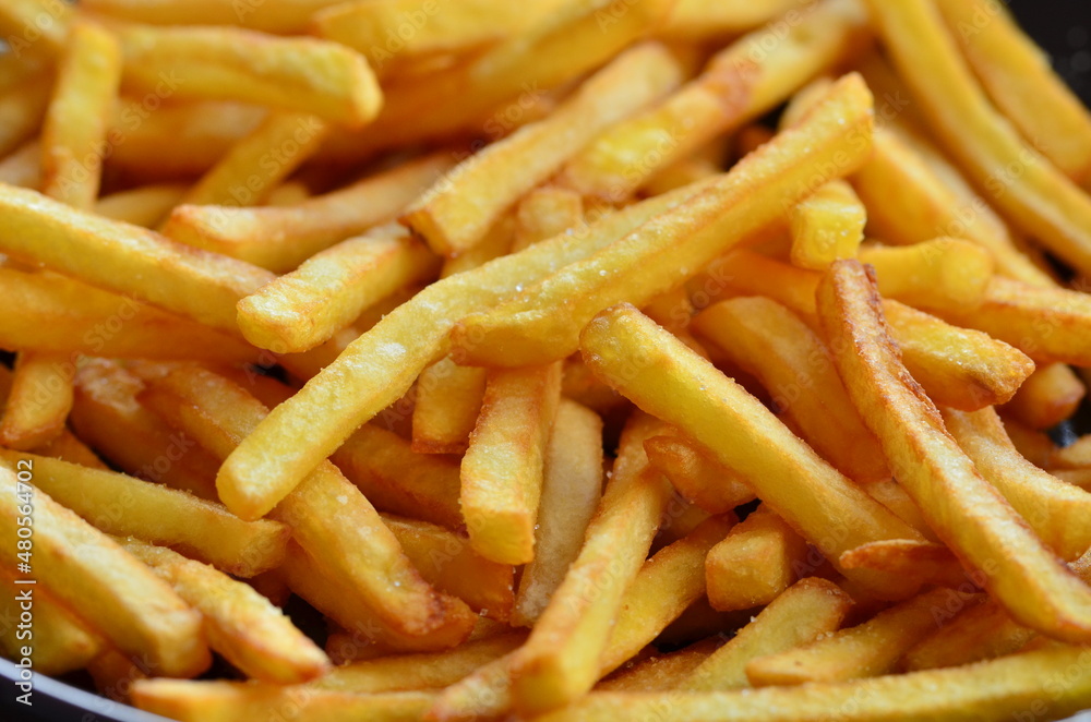 Background texture of golden French fries or Pommes Frites sliced thin ...