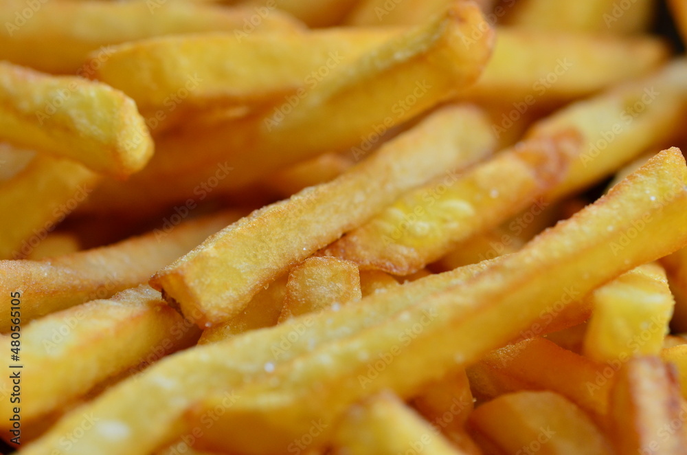 Background texture of golden French fries or Pommes Frites sliced thin ...