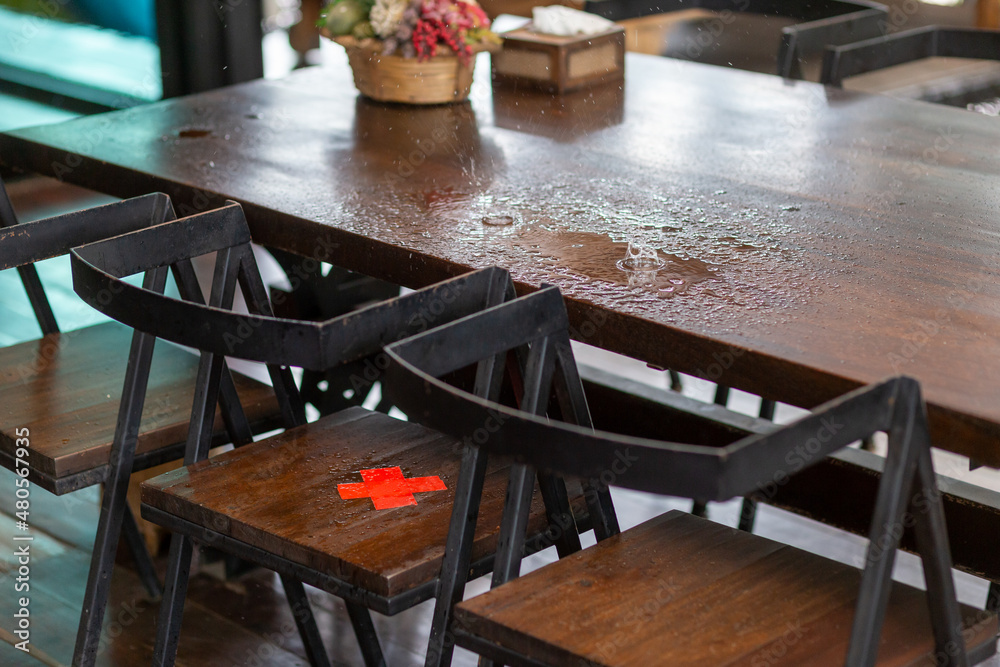 selective focus wooden table in a restaurant maintain the distance ...