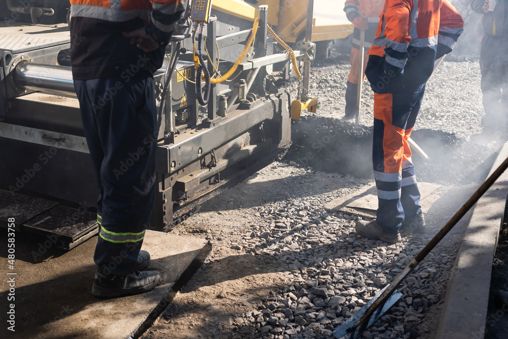 Road construction. Concrete borders. Workers at work. Stock Photo ...