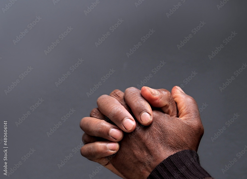 man praying to god with hands together on dark background Stock Photo ...
