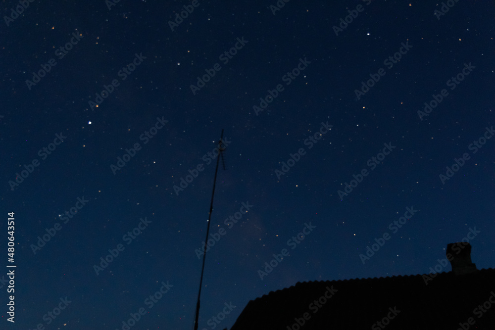 Defocus beautiful night sky. House, roof, chimney and antenna. Starry ...
