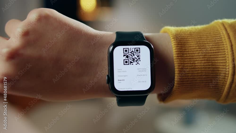 Woman showing vaccination passport on smartwatches, covid qr code close ...