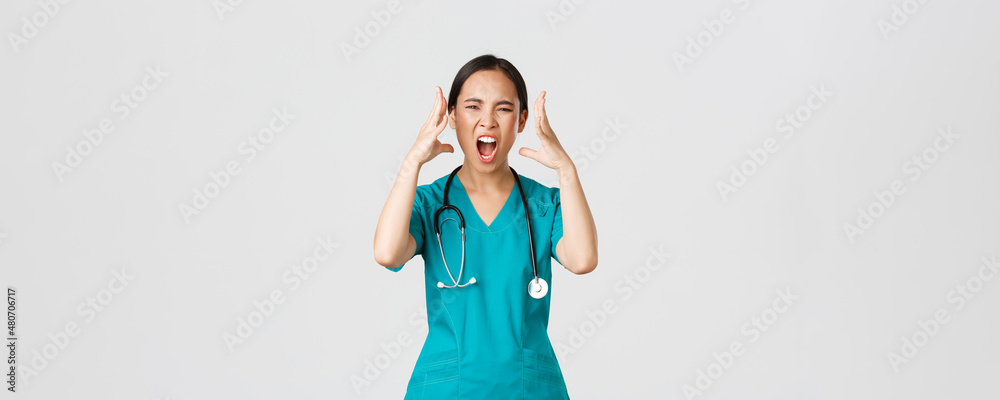 Covid-19, healthcare workers and preventing virus concept. Annoyed and ...