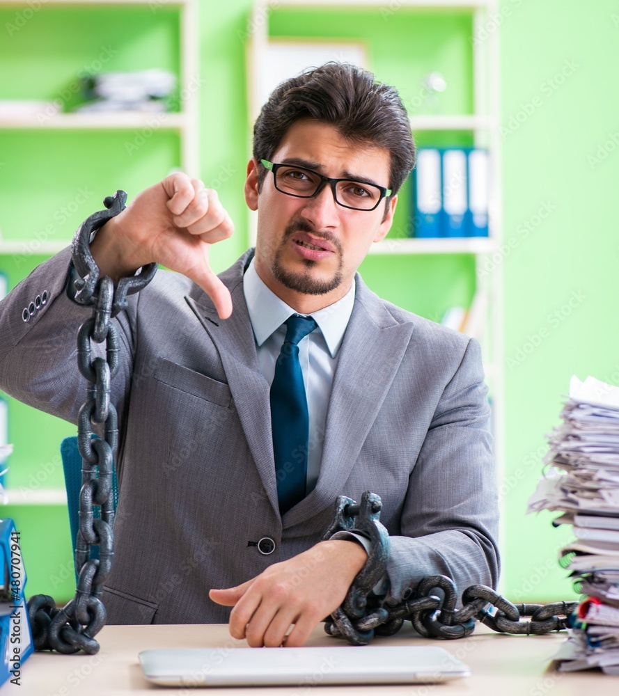Employee chained to his desk due to workload Stock Photo | Adobe Stock