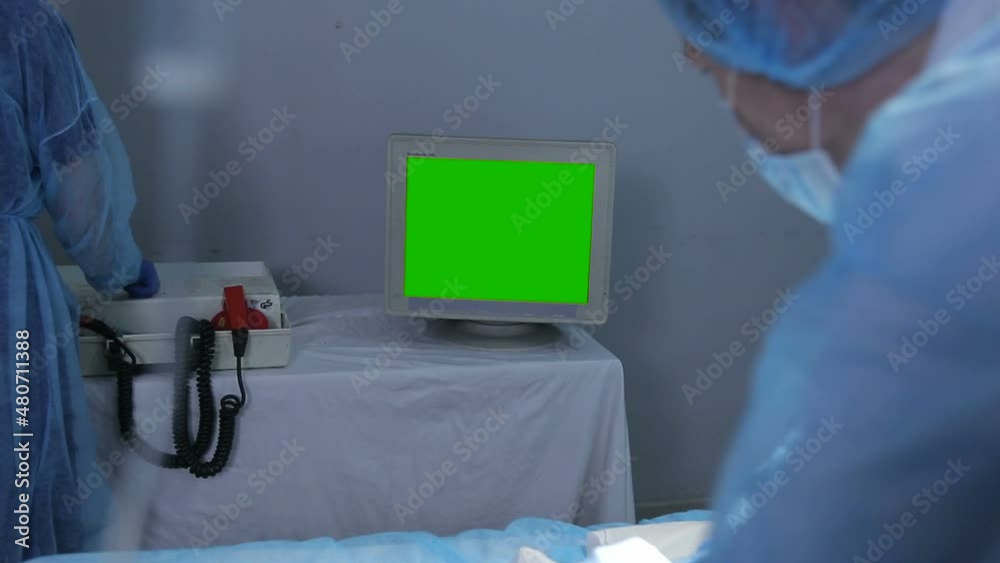 Doctor in operating room trying to help on intensive care patient ...