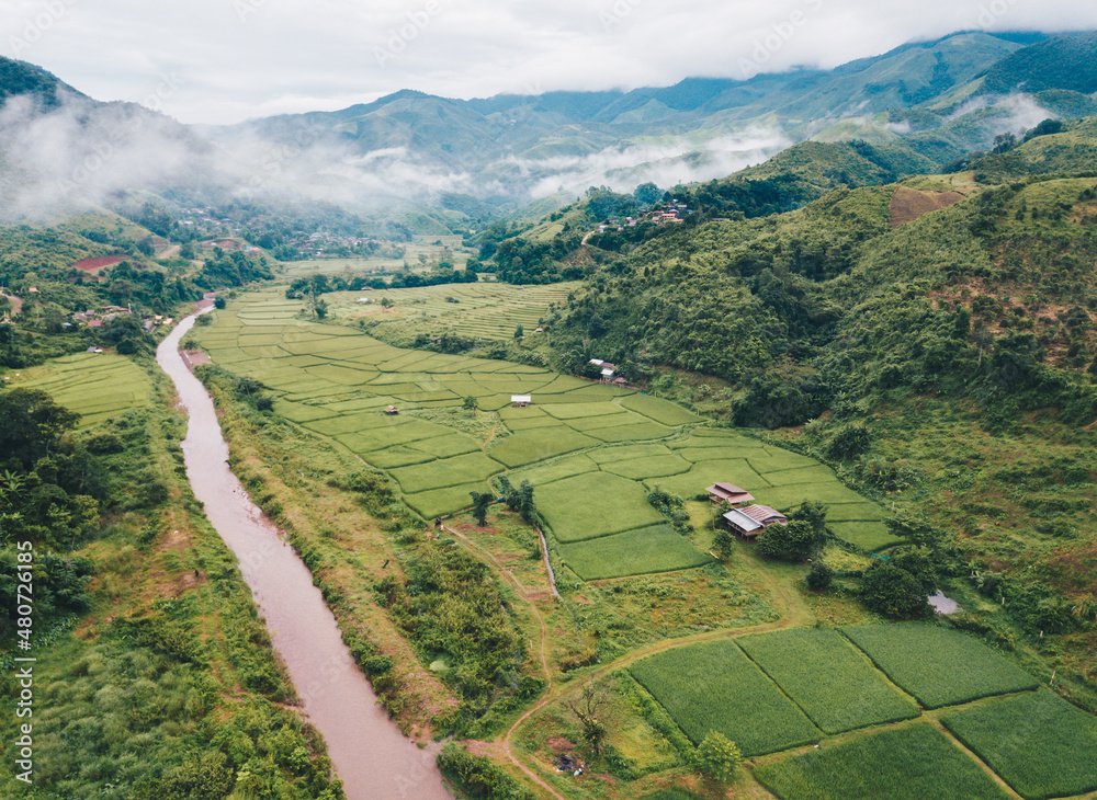 Beautiful aerial view of Wah river runs through rice paddy field in ...