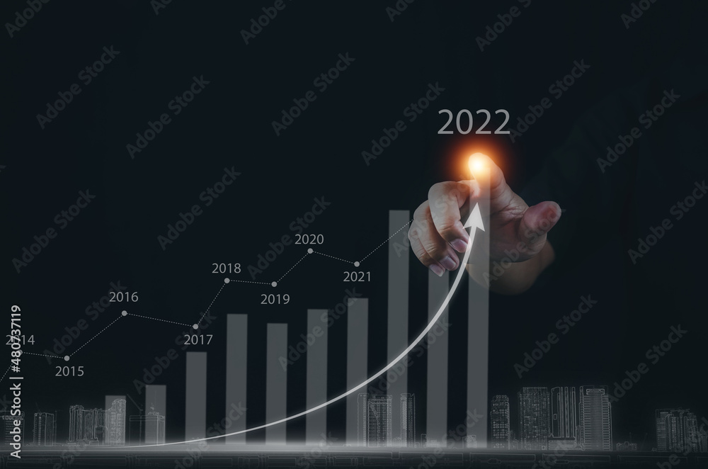 Businessman pointing to the growing plan of successful business in 2022 ...