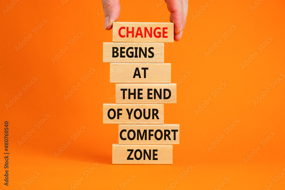 Out from comfort zone symbol. Wooden blocks with words Change begins at ...