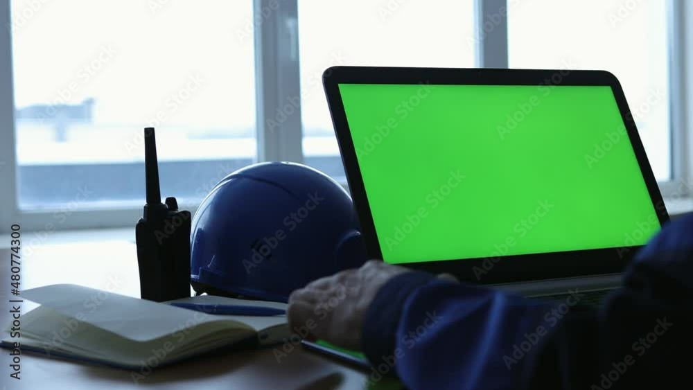 Male Engineer work at Laptop Computer with Green Screen inside office ...