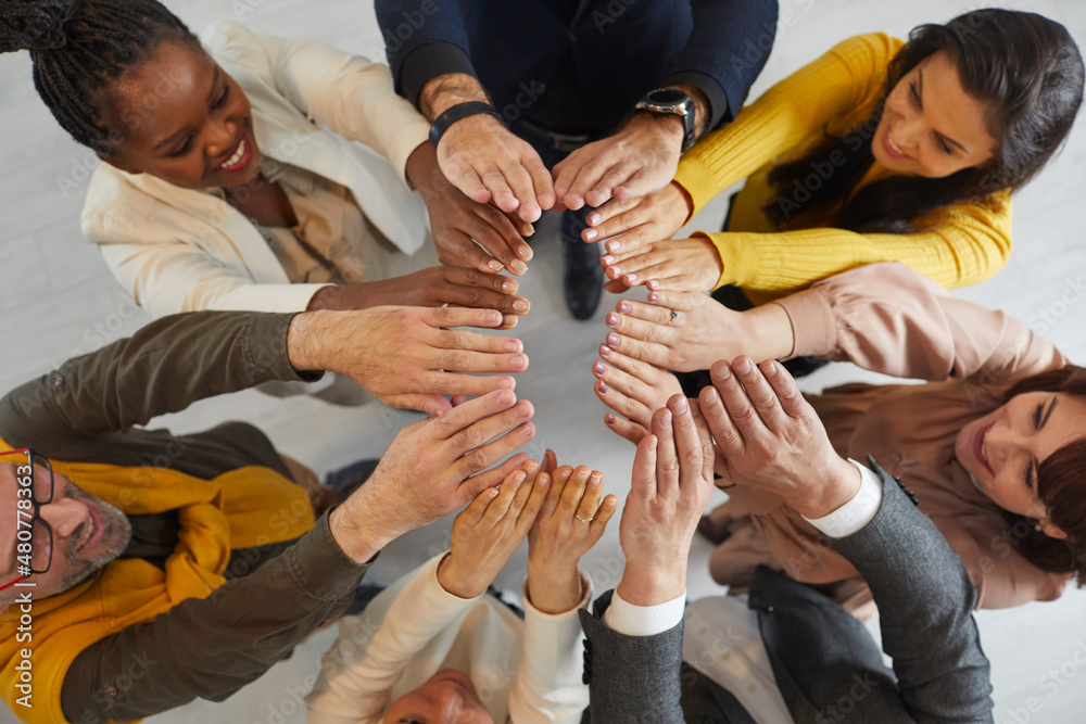 Happy diverse business team joining hands. Group of different mixed ...