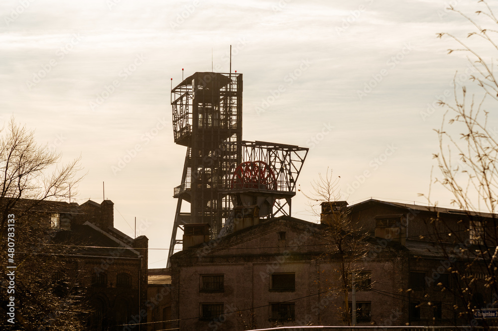 Old coal mine shaft tower with abandoned red brick buildings Stock ...