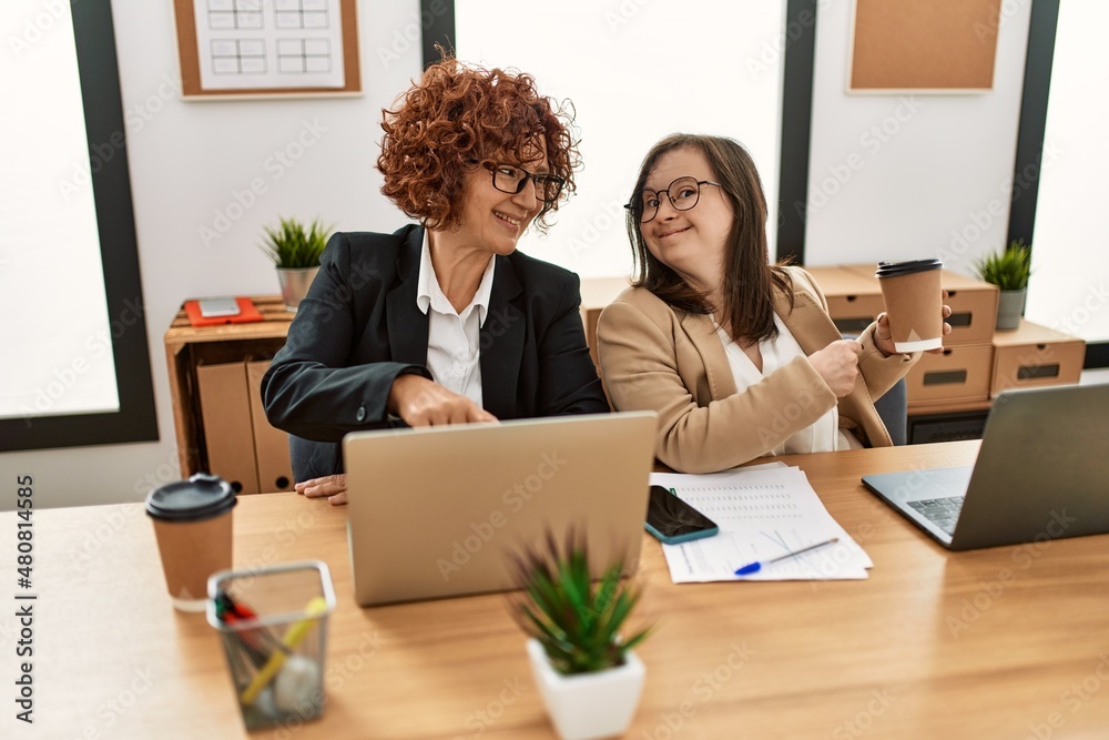 Group of two women working at the office. Mature woman and down ...