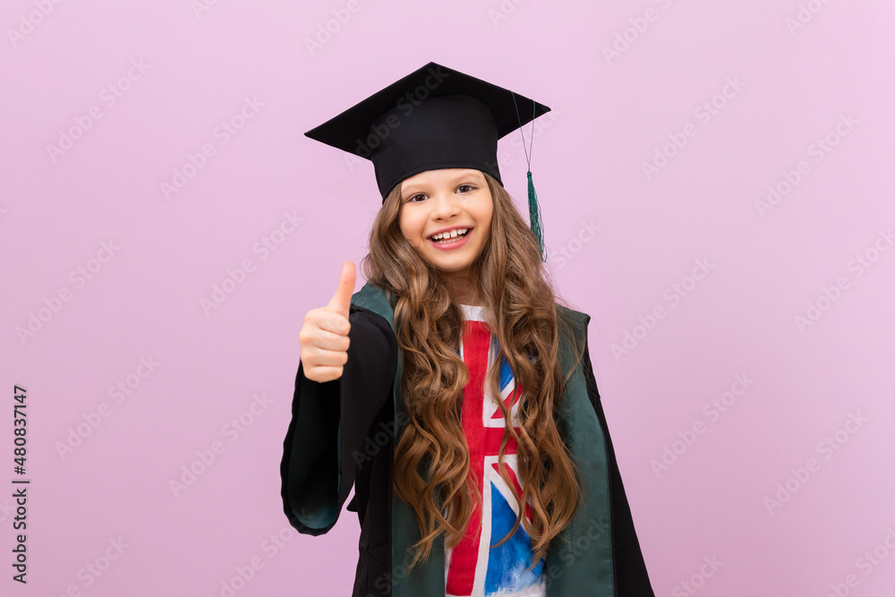 A schoolgirl in a graduation uniform points her finger up at the ...