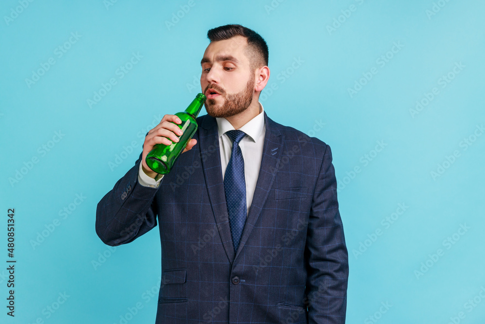 Bearded young adult businessman wearing official style suit drinking ...