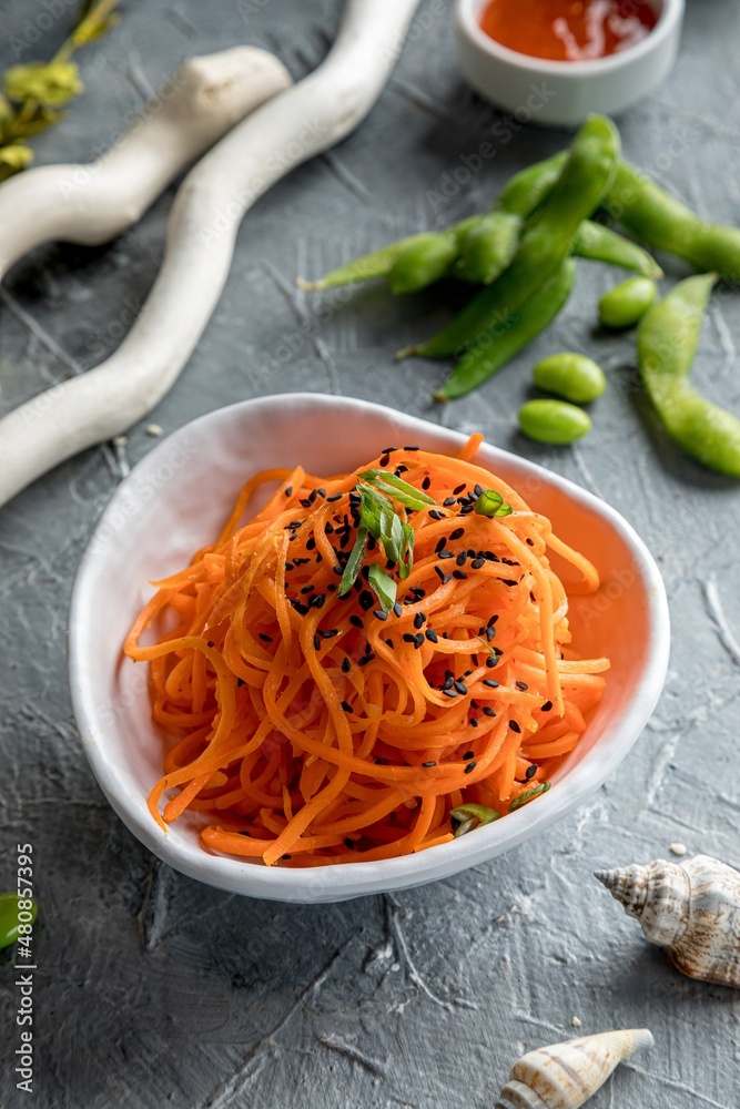 Morkovcha. Korean-style spicy carrots with black sesame seeds and green ...