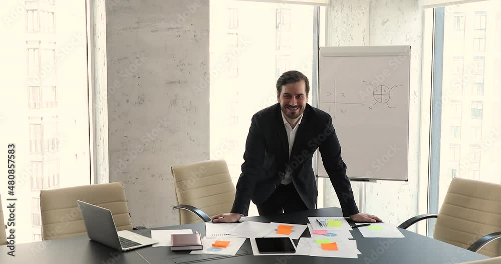 Confident young 35s businessman in formal suit pose at workplace ...