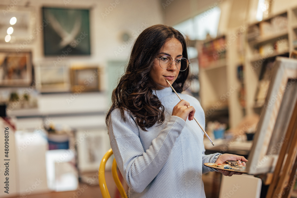 Thoughtful adult female painter, coming up with ideas for a new ...