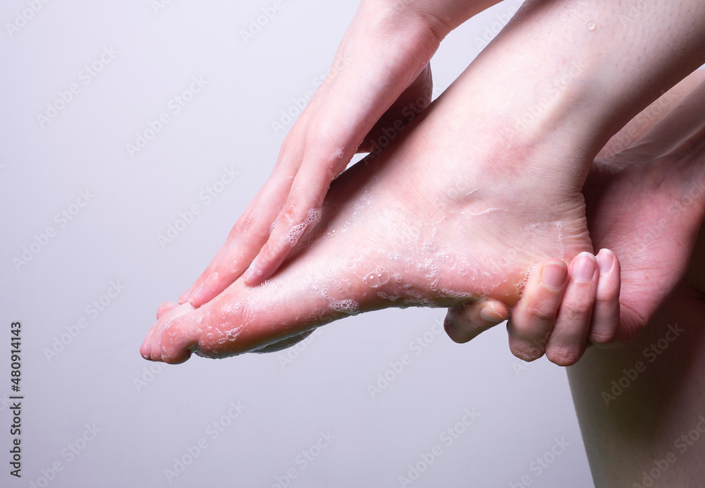 Washing your feet. Foam feet. Wash your feet with soap Stock Photo ...