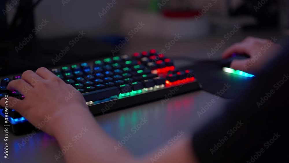 An esports player plays computer games on a professional gaming wired ...