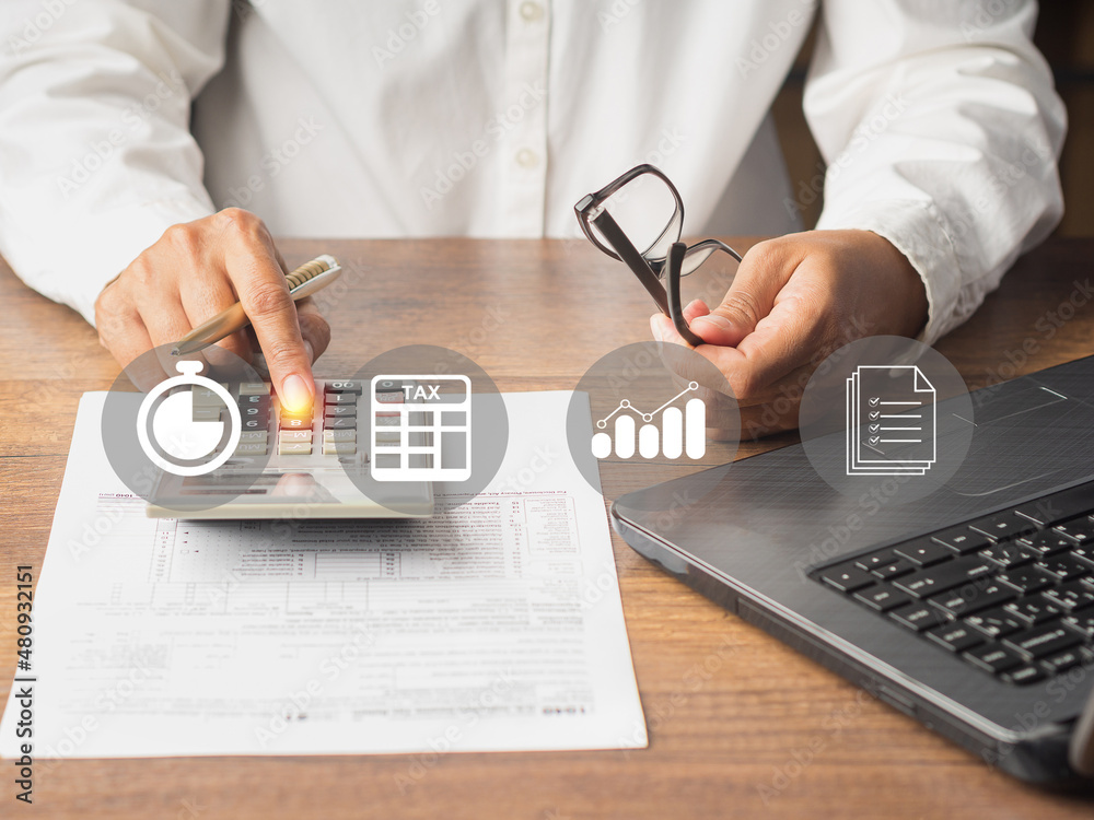 Tax payment and calculation tax return. Businessman using a calculator ...