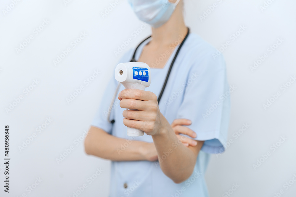 Temperature measurement gun in doctor hands. Close-up shot of doctor ...