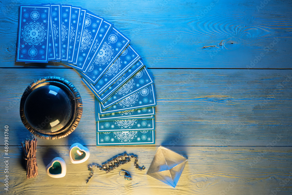 Tarot cards and crystal ball on the wooden table of the fortune teller ...