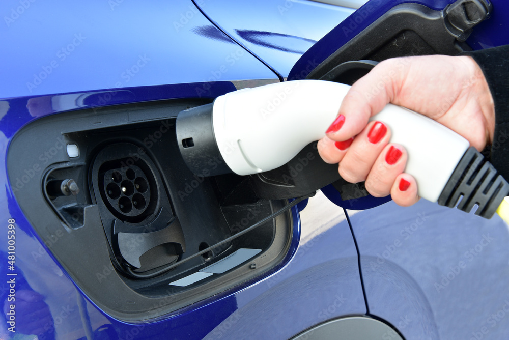 Connecting the electric car charging connector Stock Photo | Adobe Stock