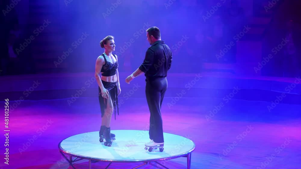 A duo of gymnasts arrange acrobatic performances on roller skates, on ...